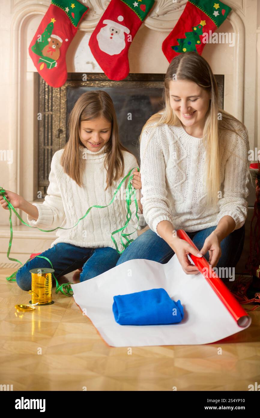 Family packing and decorating presents for Christmas Stock Photo - Alamy