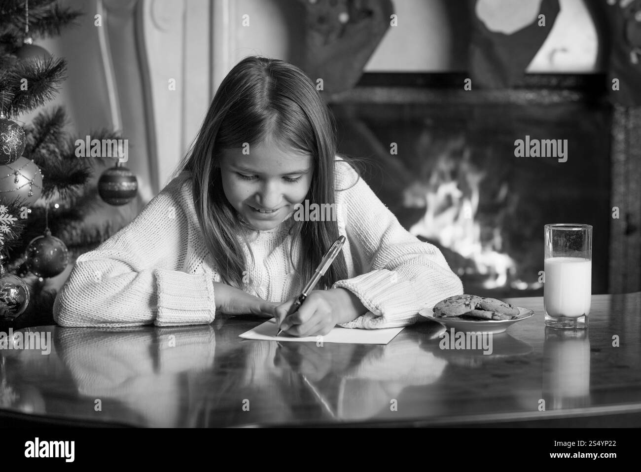 Black and white portrait of cute girl writing letter to Santa Stock ...