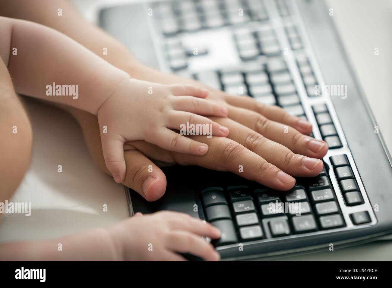 Closeup of fathers and babys hands on computer keyboard Stock Photo - Alamy