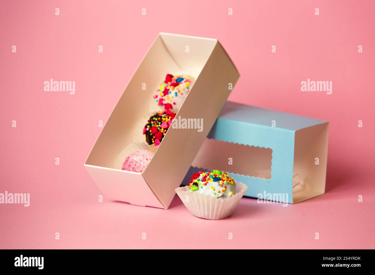 Open gift box with colorful cake balls and candies with sprinkles Stock ...