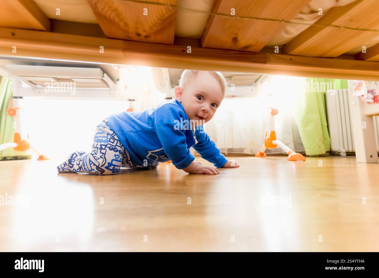 View from under the bed on cute baby crawling on floor Stock Photo - Alamy