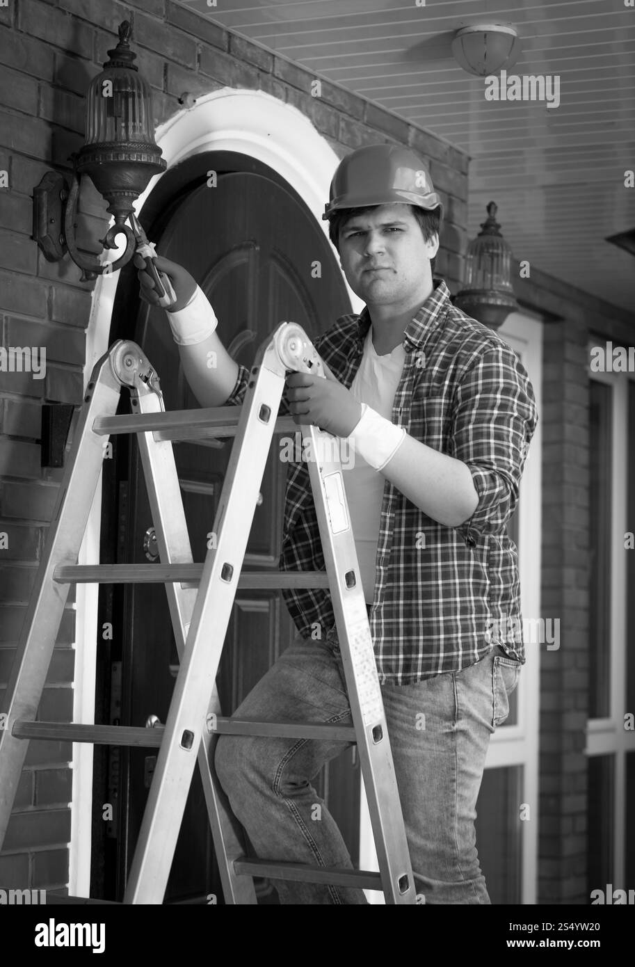 Black and white portrait of electrician posing on stepladder Stock ...