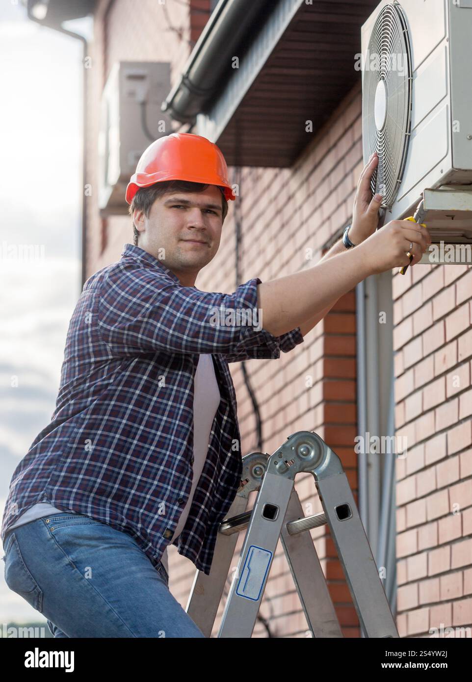 Professional young repairman fixing hi-res stock photography and images ...