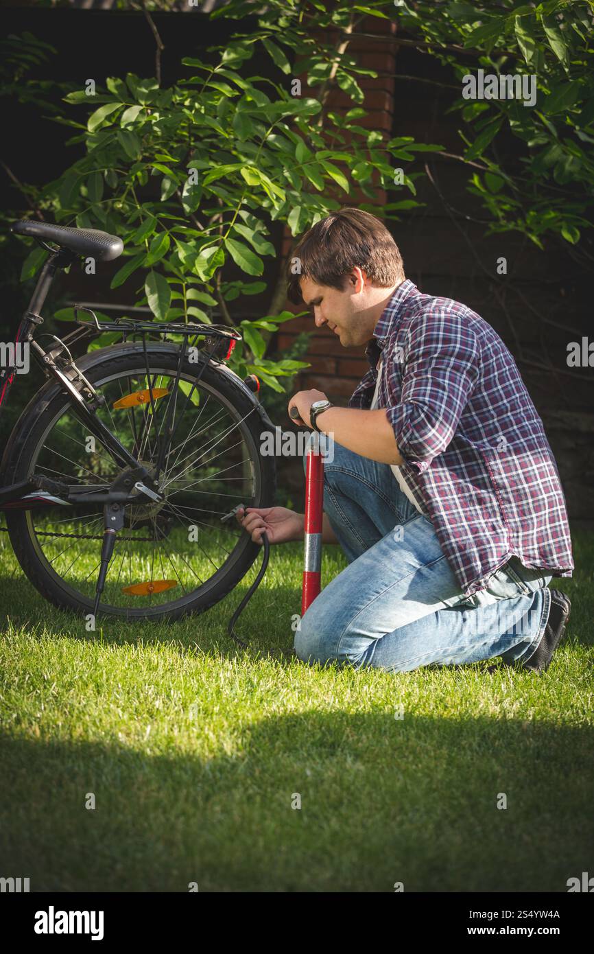 Man sitting on grass bicycle hi-res stock photography and images - Alamy