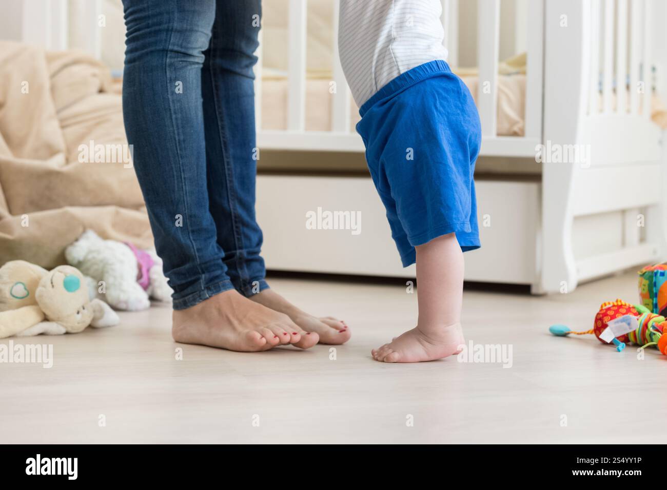 Closeup image of 10 months old baby boy making first steps Stock Photo ...