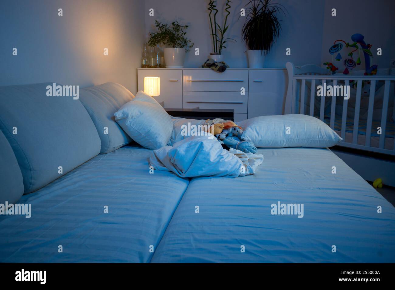 Empty bed in bedroom at night Stock Photo - Alamy