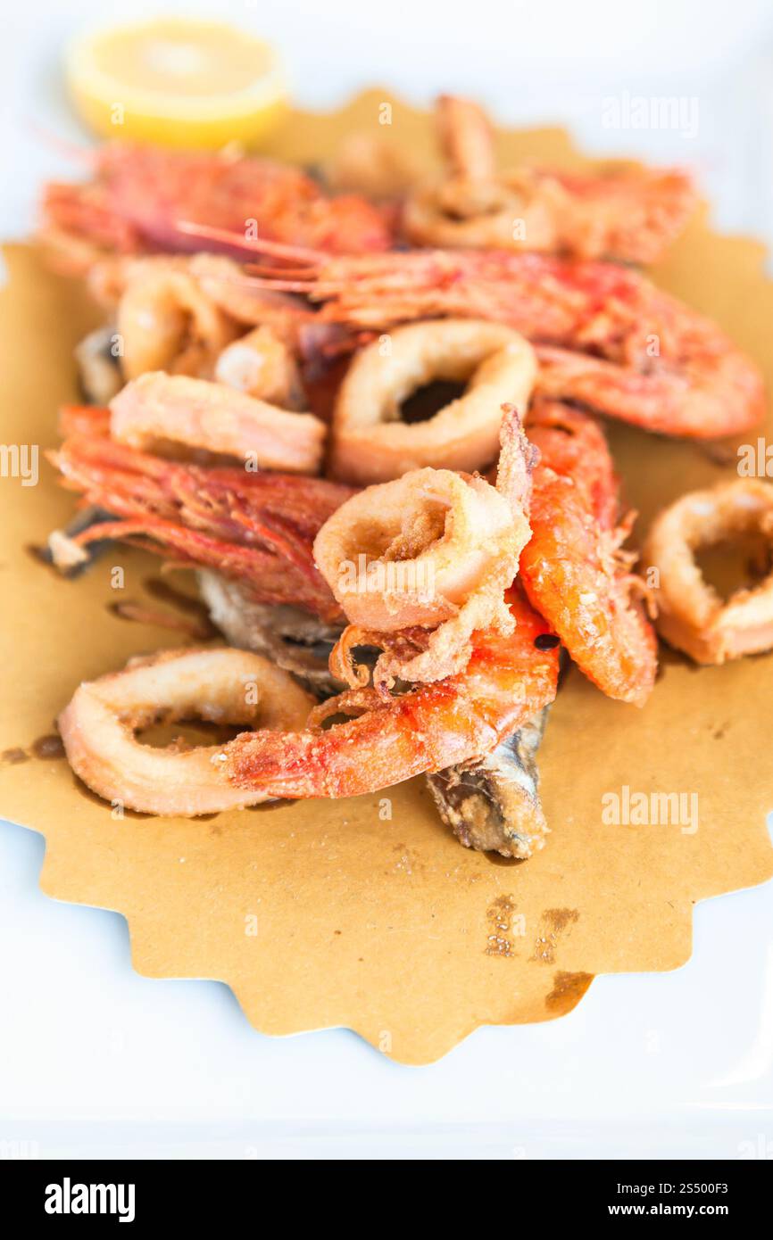 typical italian food - plate with fried local fishes and seafood in ...