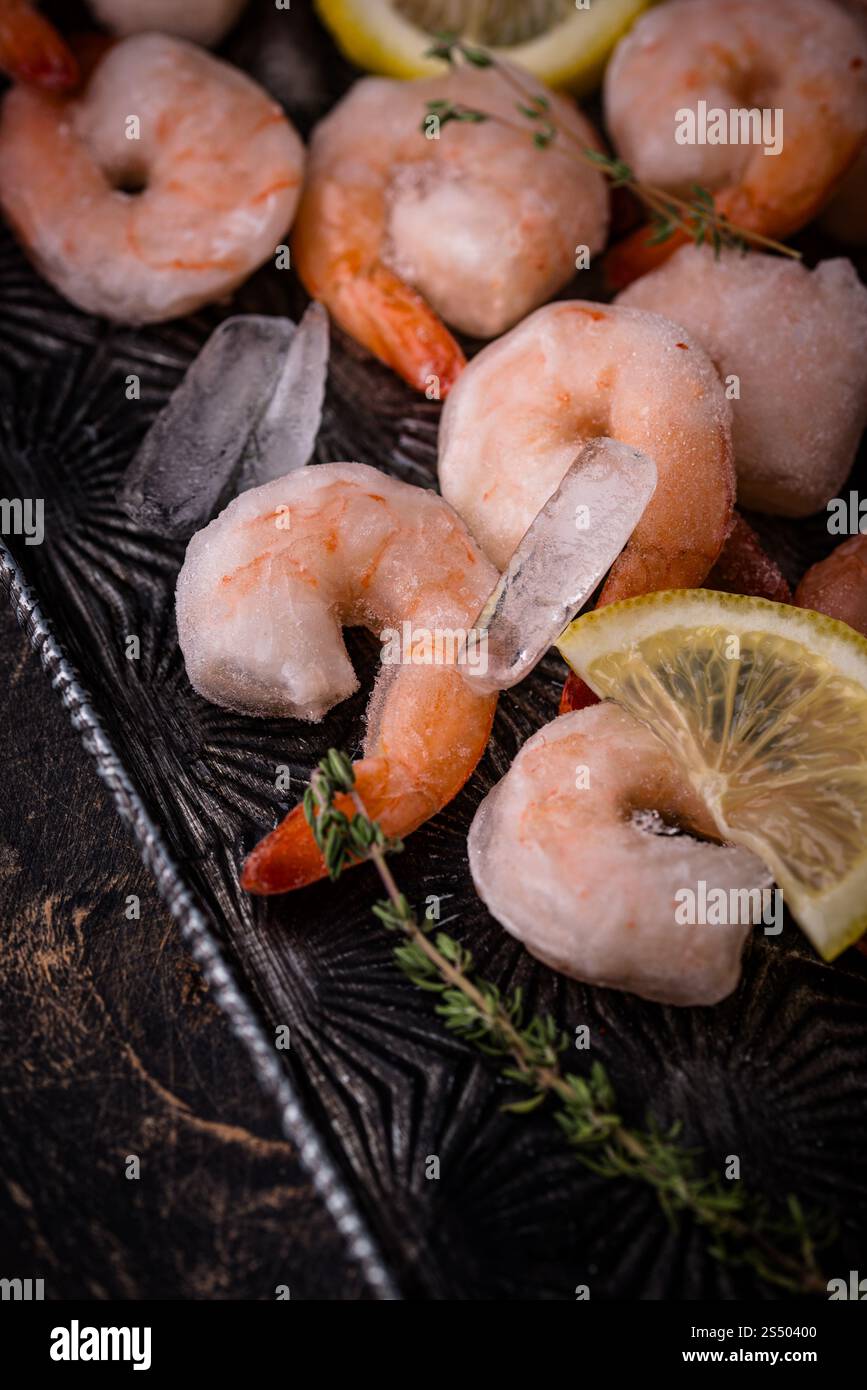 Frozen uncooked prawns or shrimps with lemon Stock Photo - Alamy