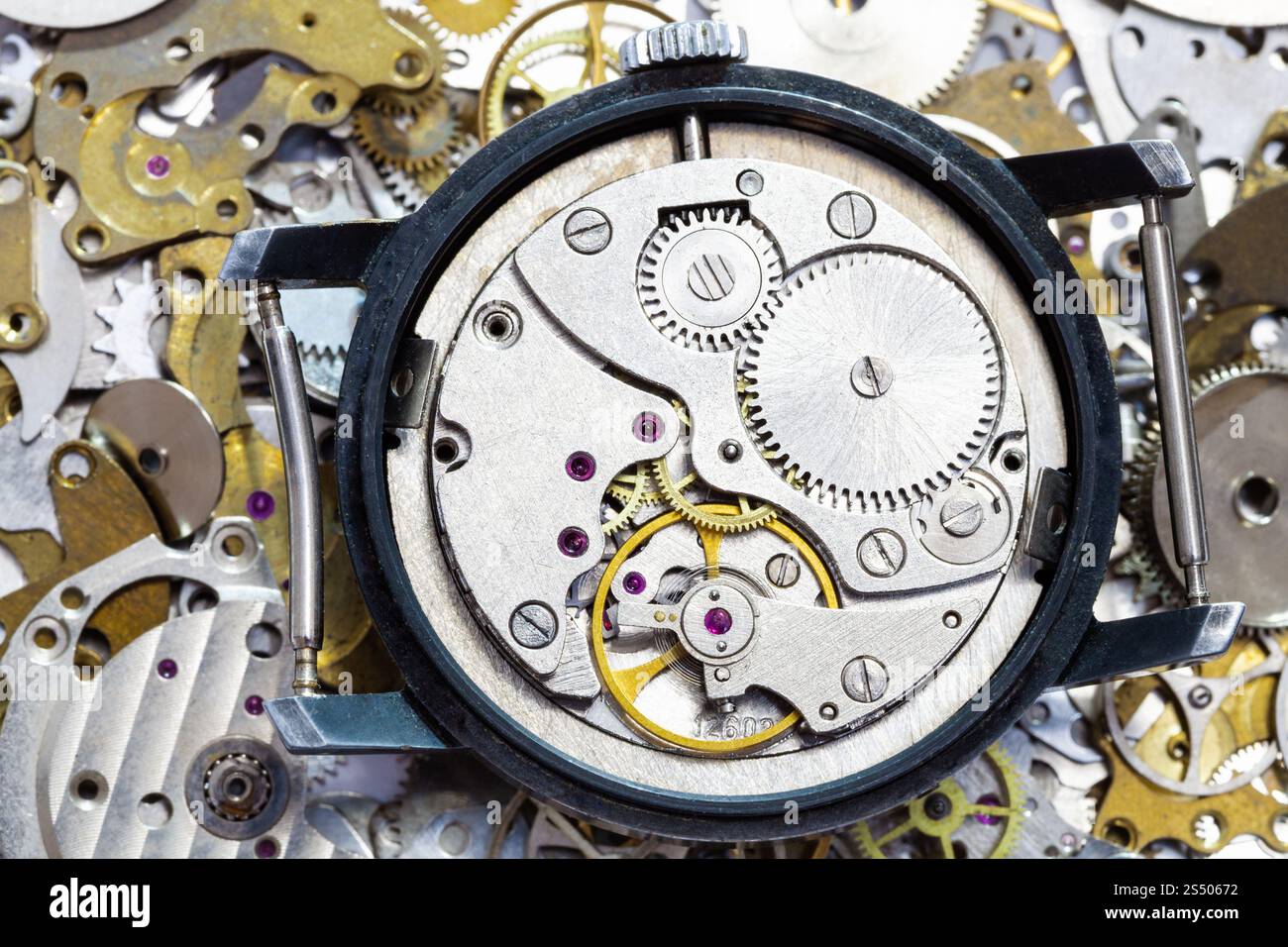 watchmaker workshop - open old mechanical watch on pile of clock spare ...