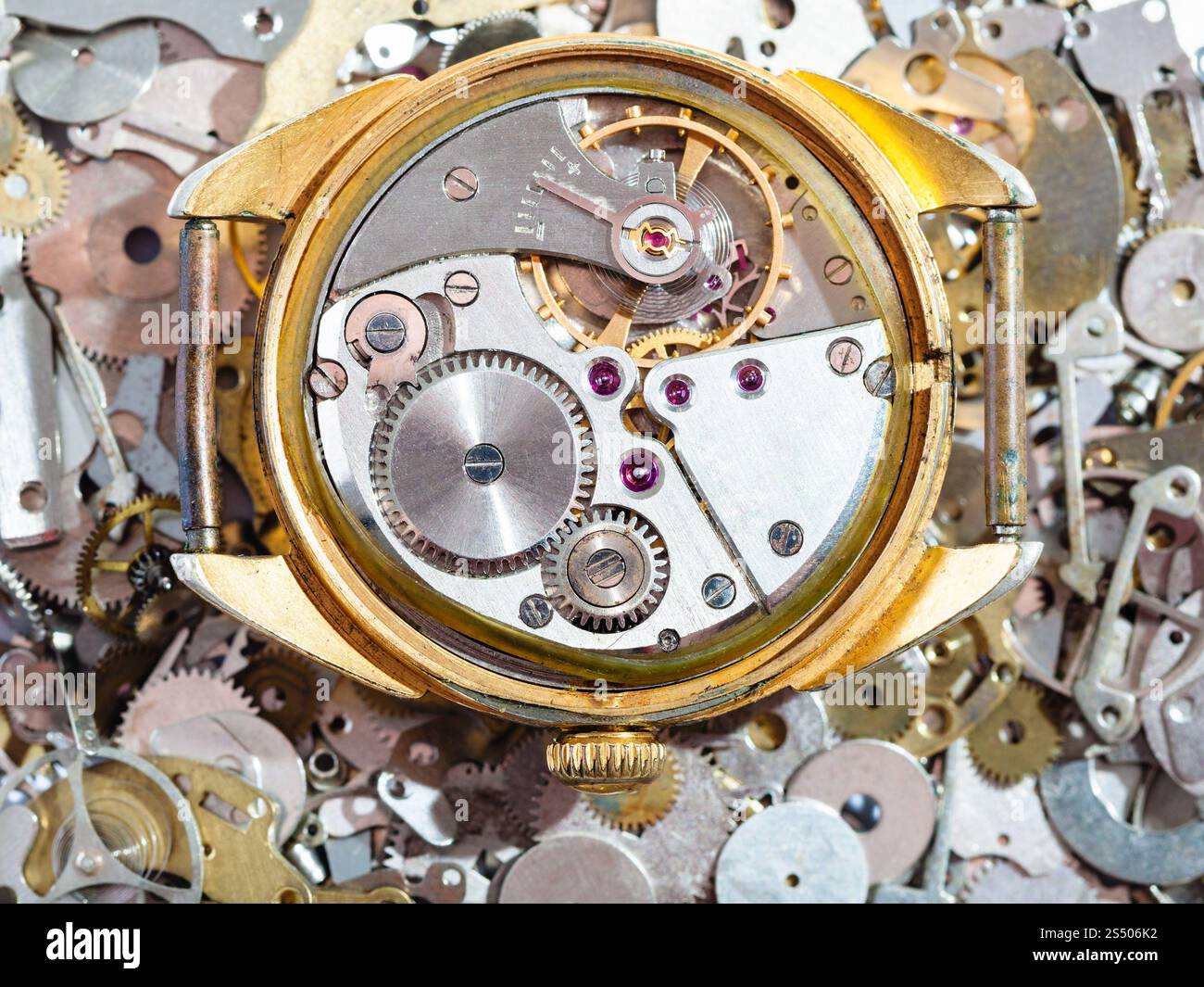 watchmaker workshop - open old golden mechanical wristwatch on heap of ...