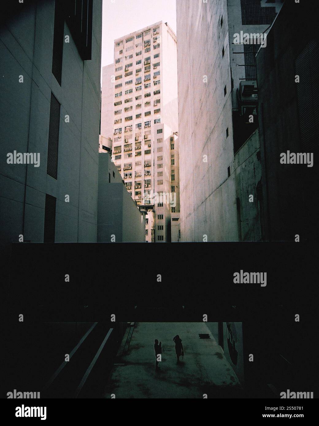 Hong Kong, China - Rooftop of shopping mall The Mills. Two silhouetted ...
