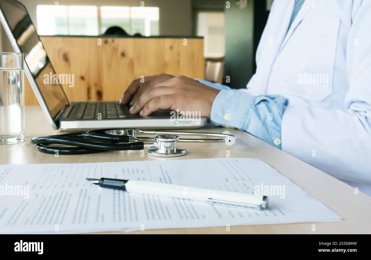 Professional medical doctor in white uniform gown coat working laptop ...