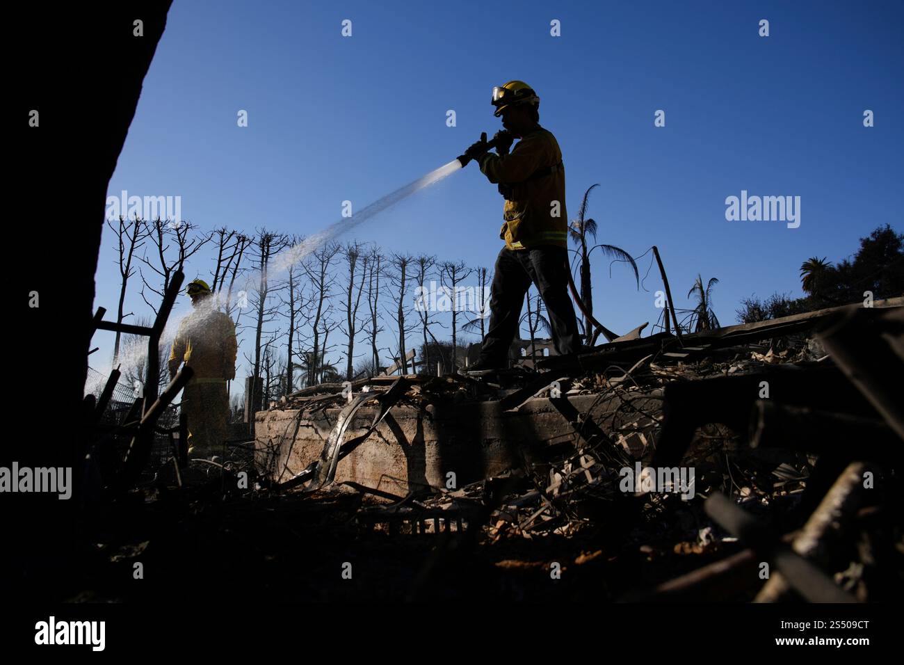 Tim Murphy, with the San Francisco Fire Dept., puts out hot spots in a ...
