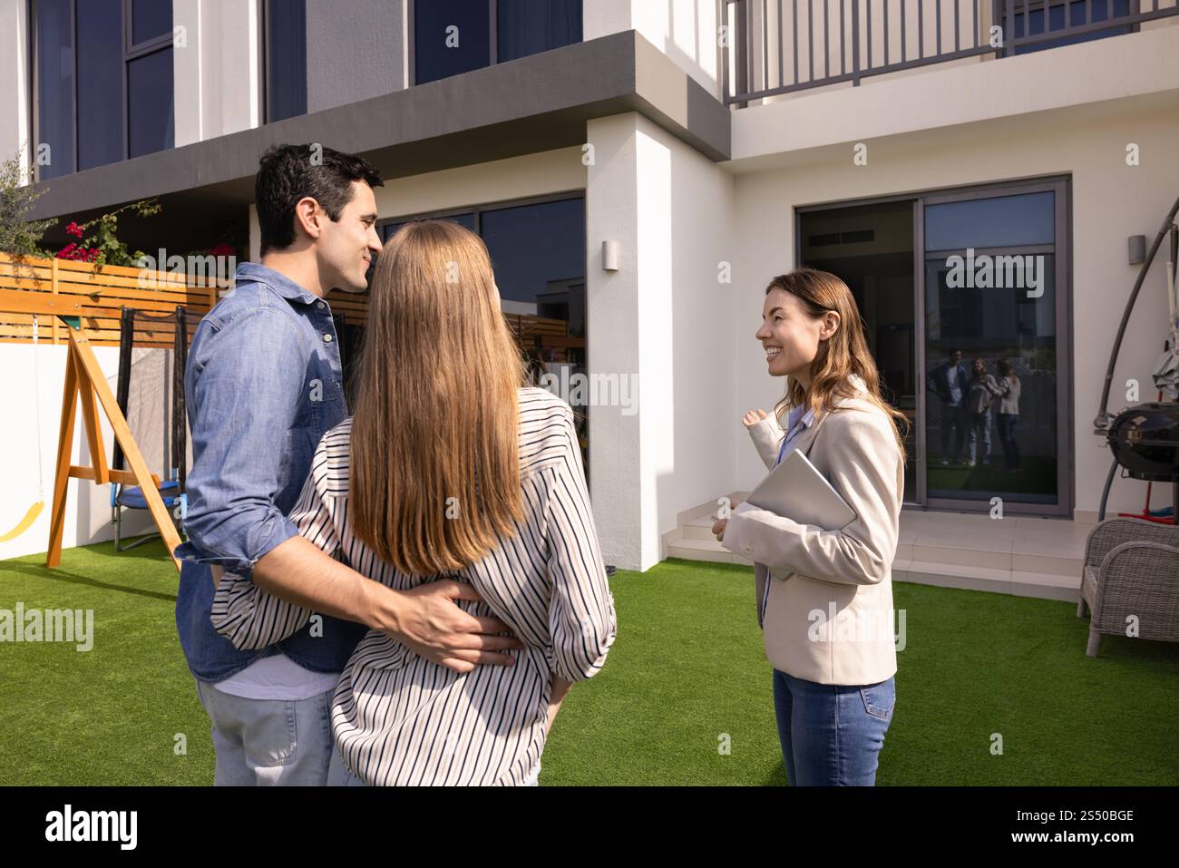 Happy real estate agent woman showing house for sale Stock Photo - Alamy