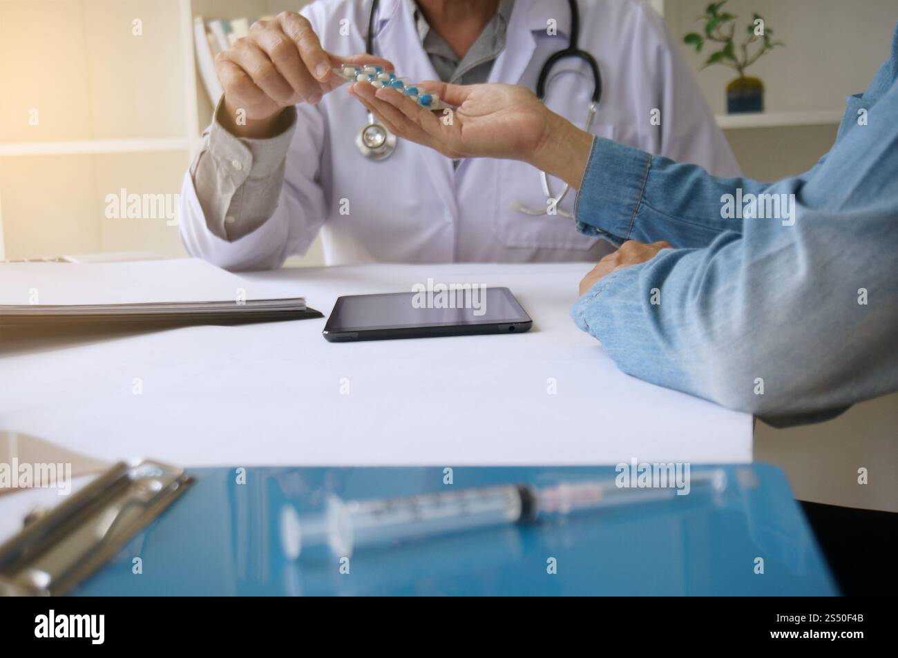 Doctor hand holding pack of different tablet blisters for patient ...