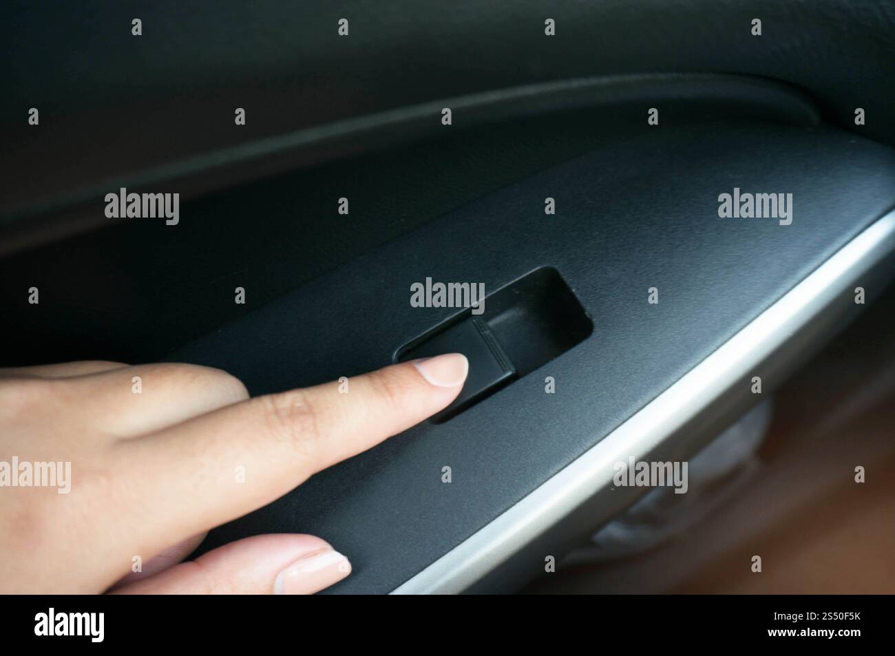 pressing button controlling window in car Stock Photo - Alamy