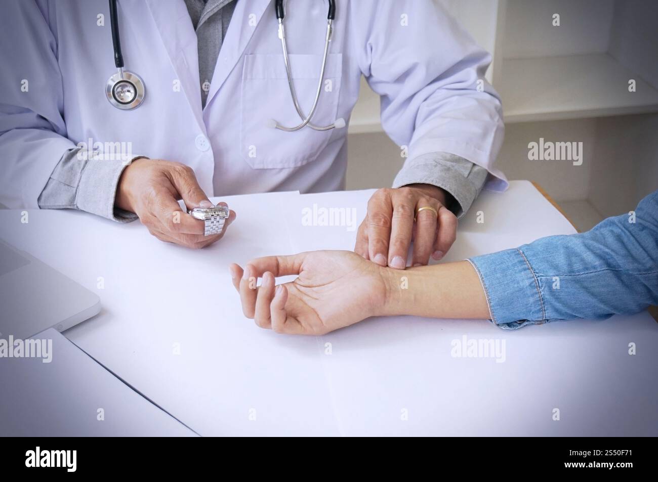 Doctor checking pulse woman patient for heartbeat. Health care concept ...
