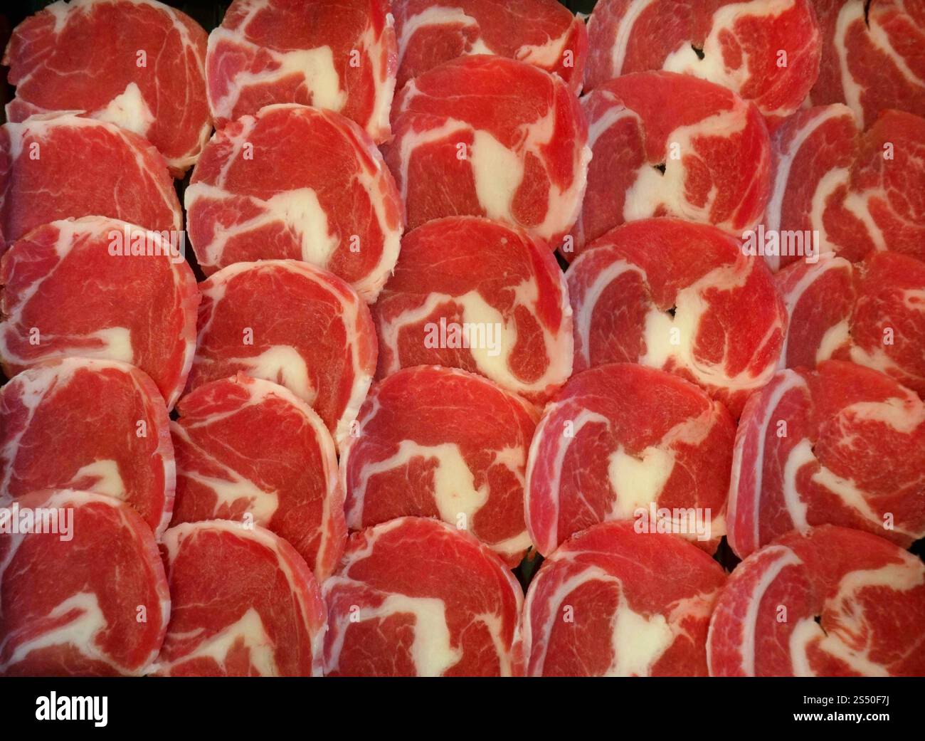 Pork raw meat slides on dish with barbecue sauce at BBQ. grill buffet ...