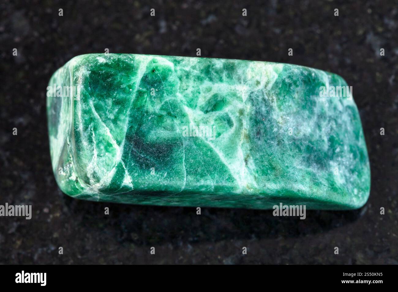 macro shooting of natural mineral rock specimen - tumbled green jadeite ...