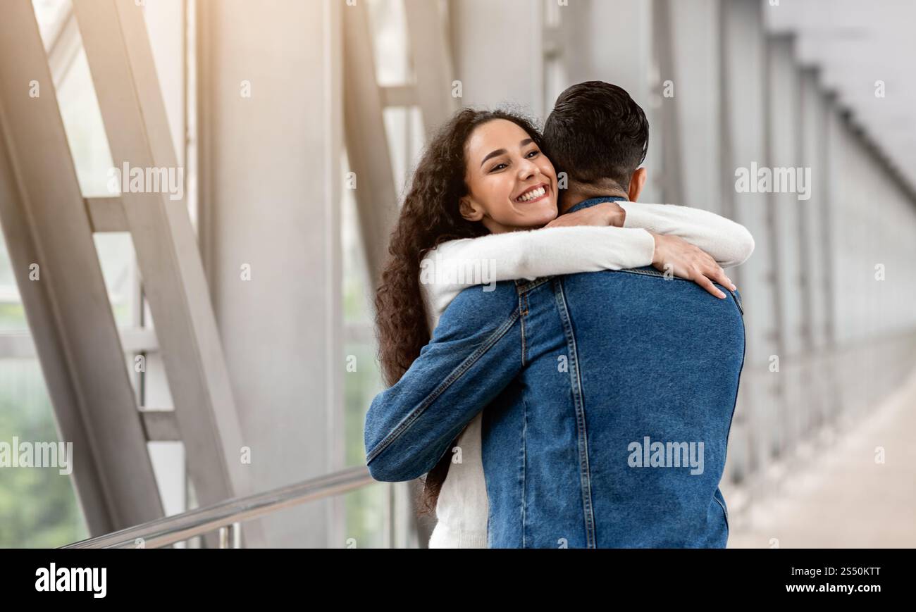 Happy Meeting. Overjoyed Young Woman Hugging Her Boyfriend At Airport After Arrival Stock Photo ...