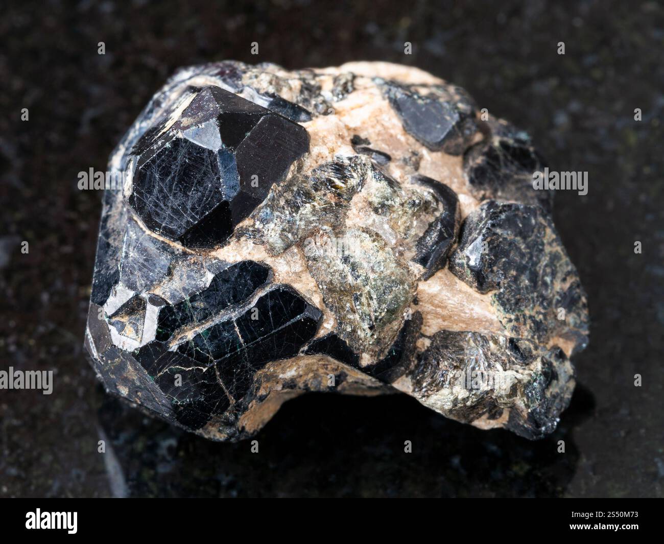macro shooting of natural mineral rock specimen - raw black crystal of ...