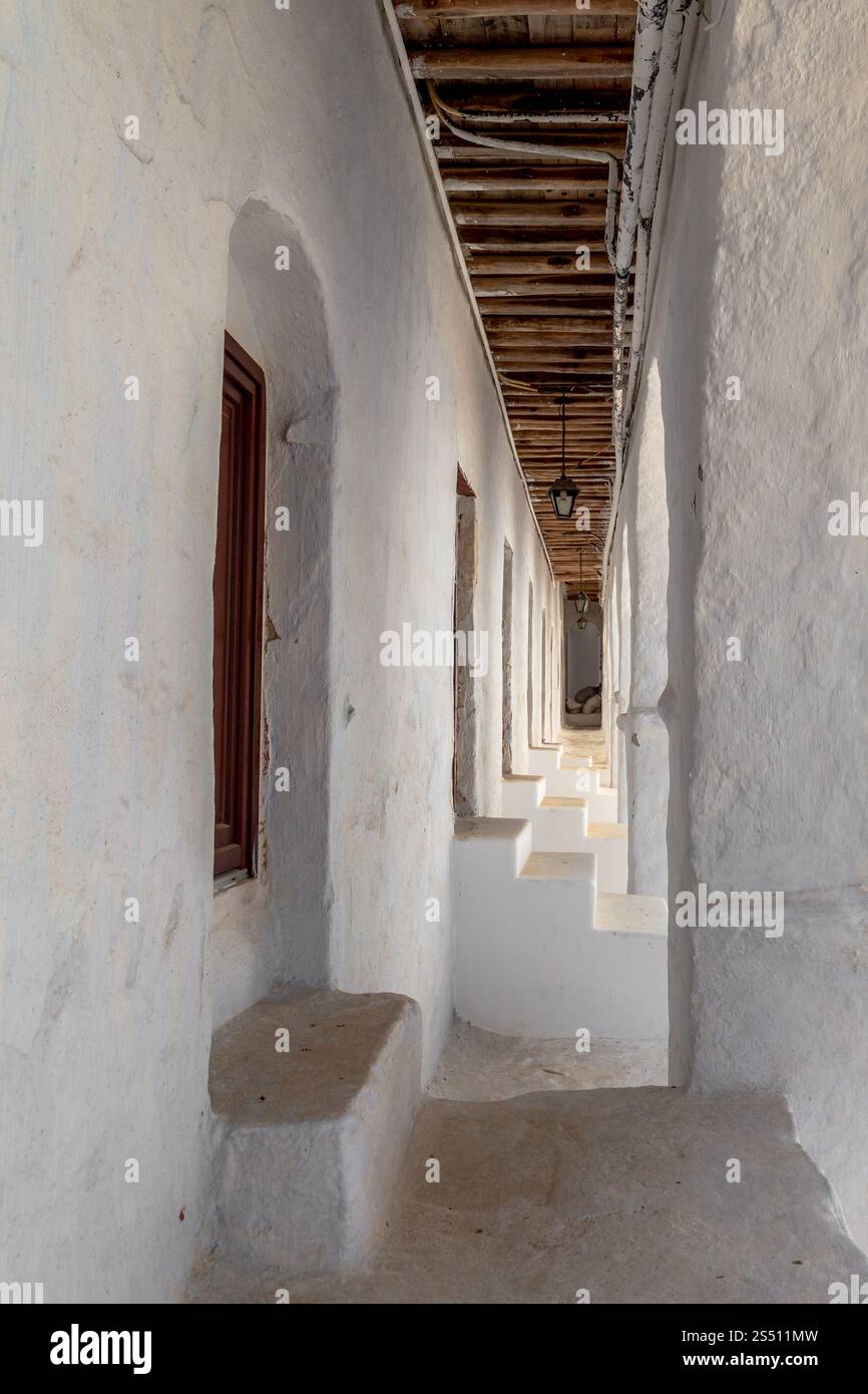 Traditional Stone Corridor with Arched Openings and Rustic Wooden ...