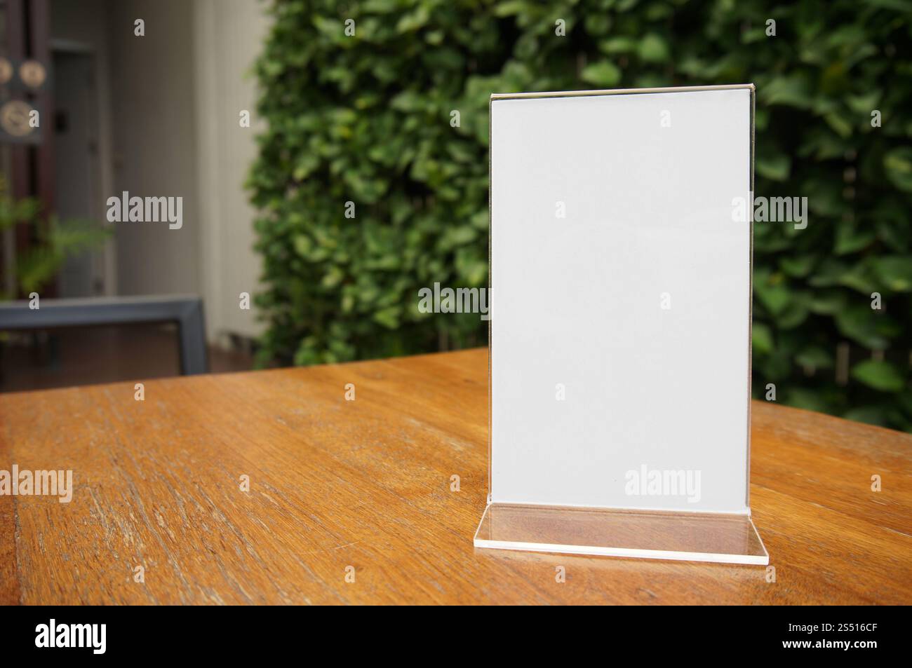 Mock up Menu frame standing on wood table in Bar restaurant cafe. space ...