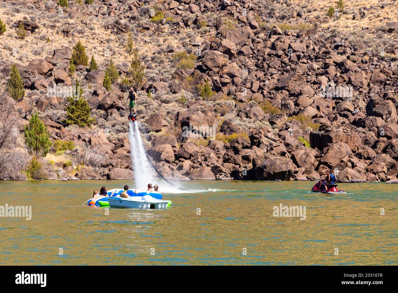 Recreational Group Enjoying Water Activities on Lake With Flyboarding ...