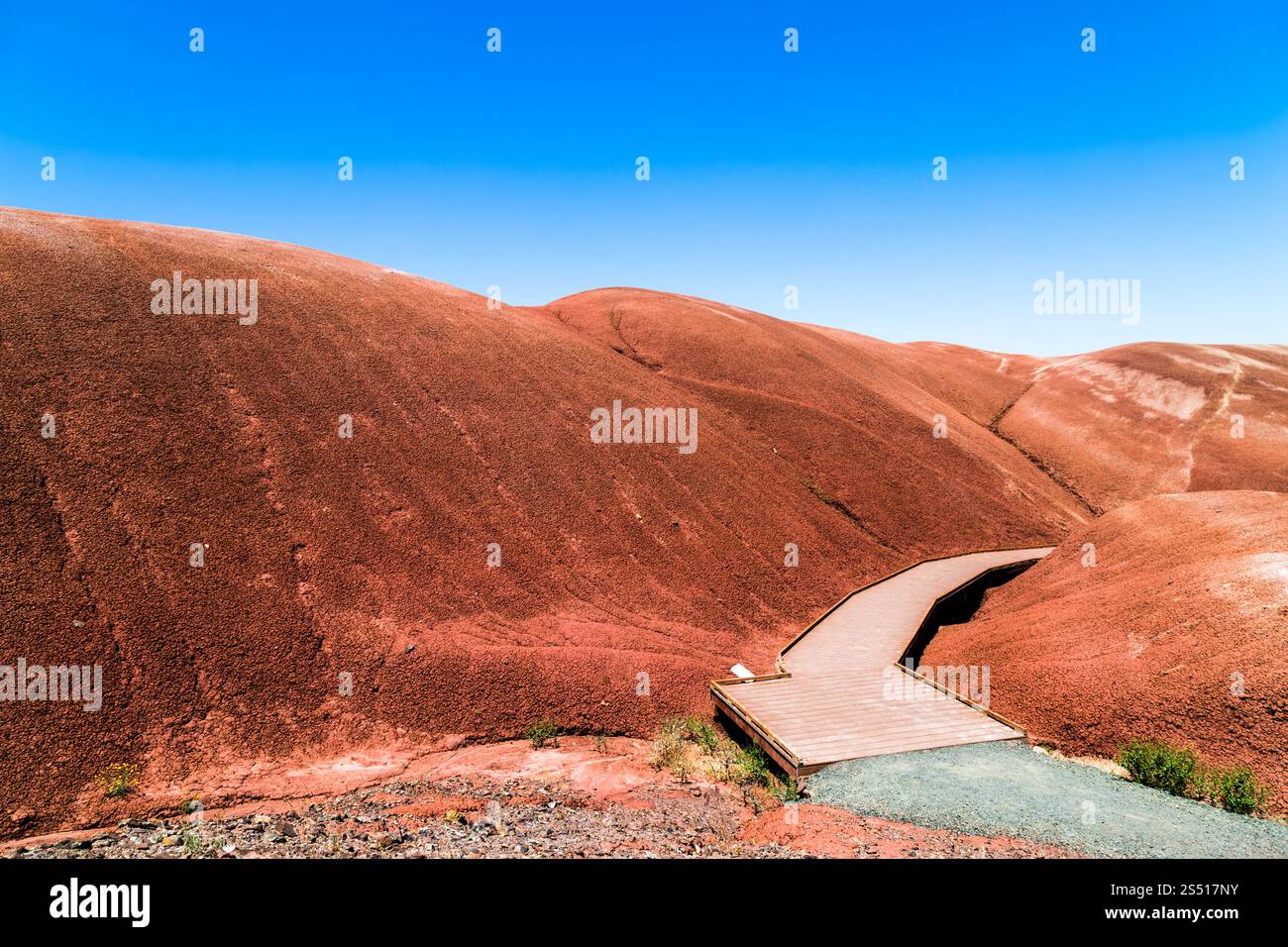 Wooden Path Through Red Sandstone Hills Beneath a Bright Sunny Sky ...