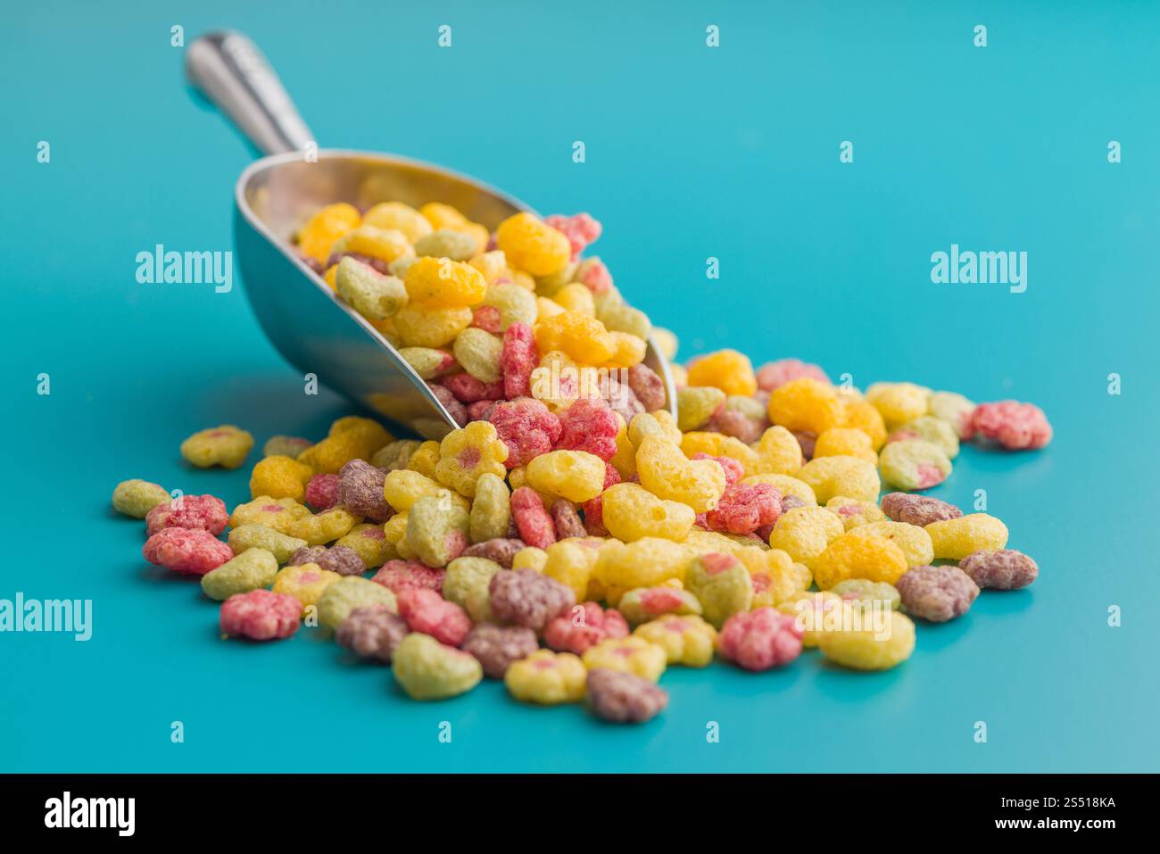 Colorful breakfast cereals in the shape of various fruit on scoop on a ...