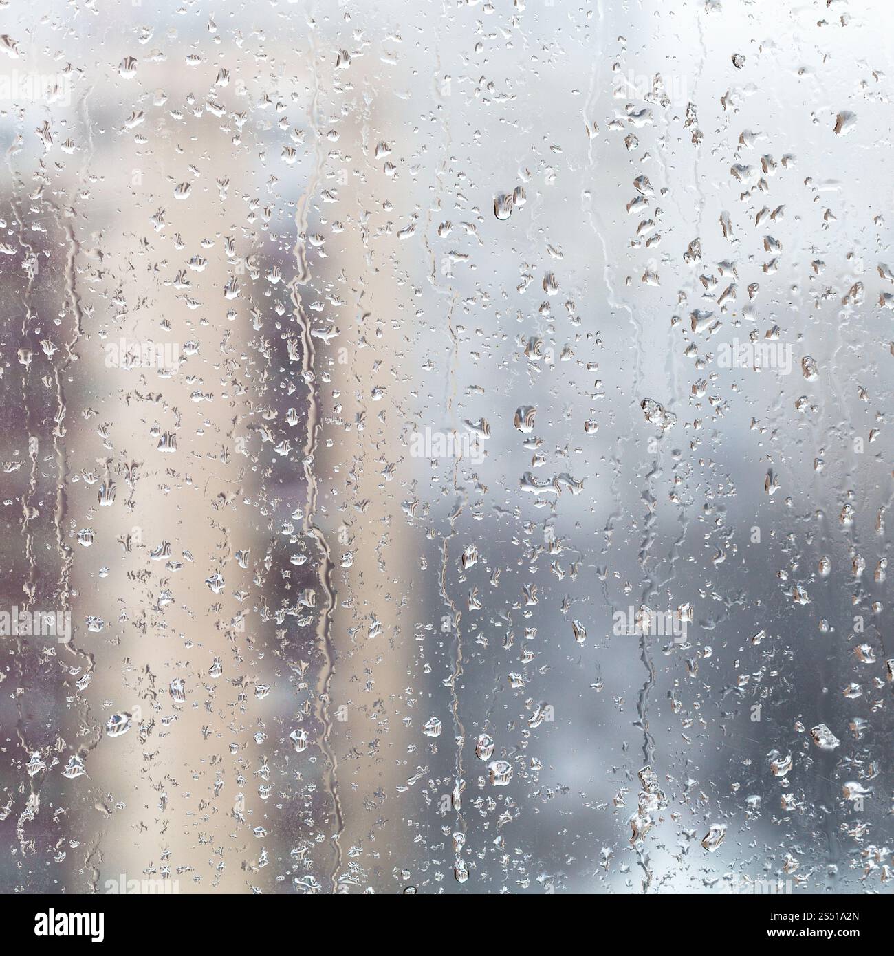 urban background - raindrops on home window glass (focus on water ...