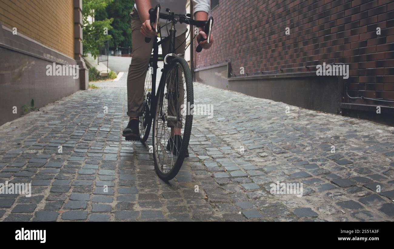 Toned image of stylish young man riding vintage bicycle on paved road ...