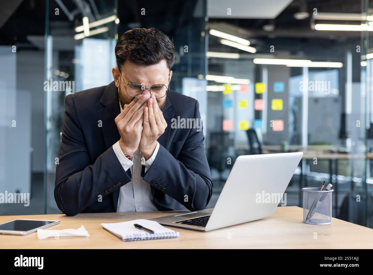 Sick man at workplace, has runny nose sneezing, allergic attack ...