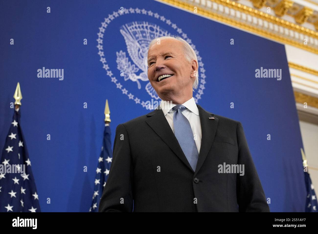 President Joe Biden smiles as he gets a standing ovation before making ...