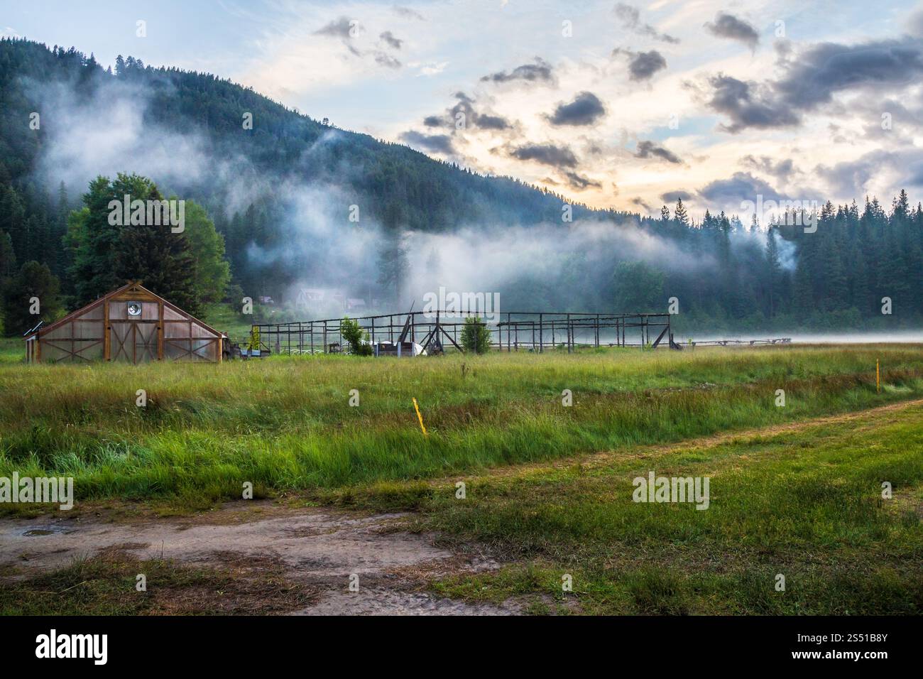 Idyllic Countryside Scene with Misty Fields and Wooden House in Nature ...