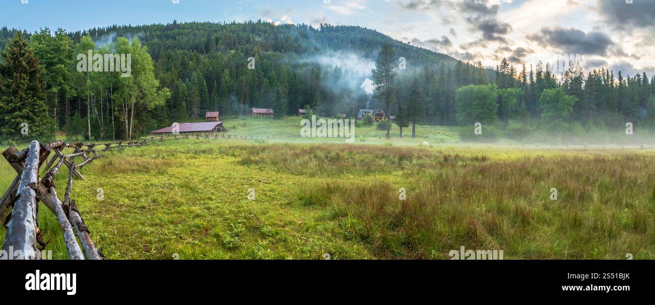 Rustic Countryside Scene with Cabin Amid Misty Meadows and Forested ...