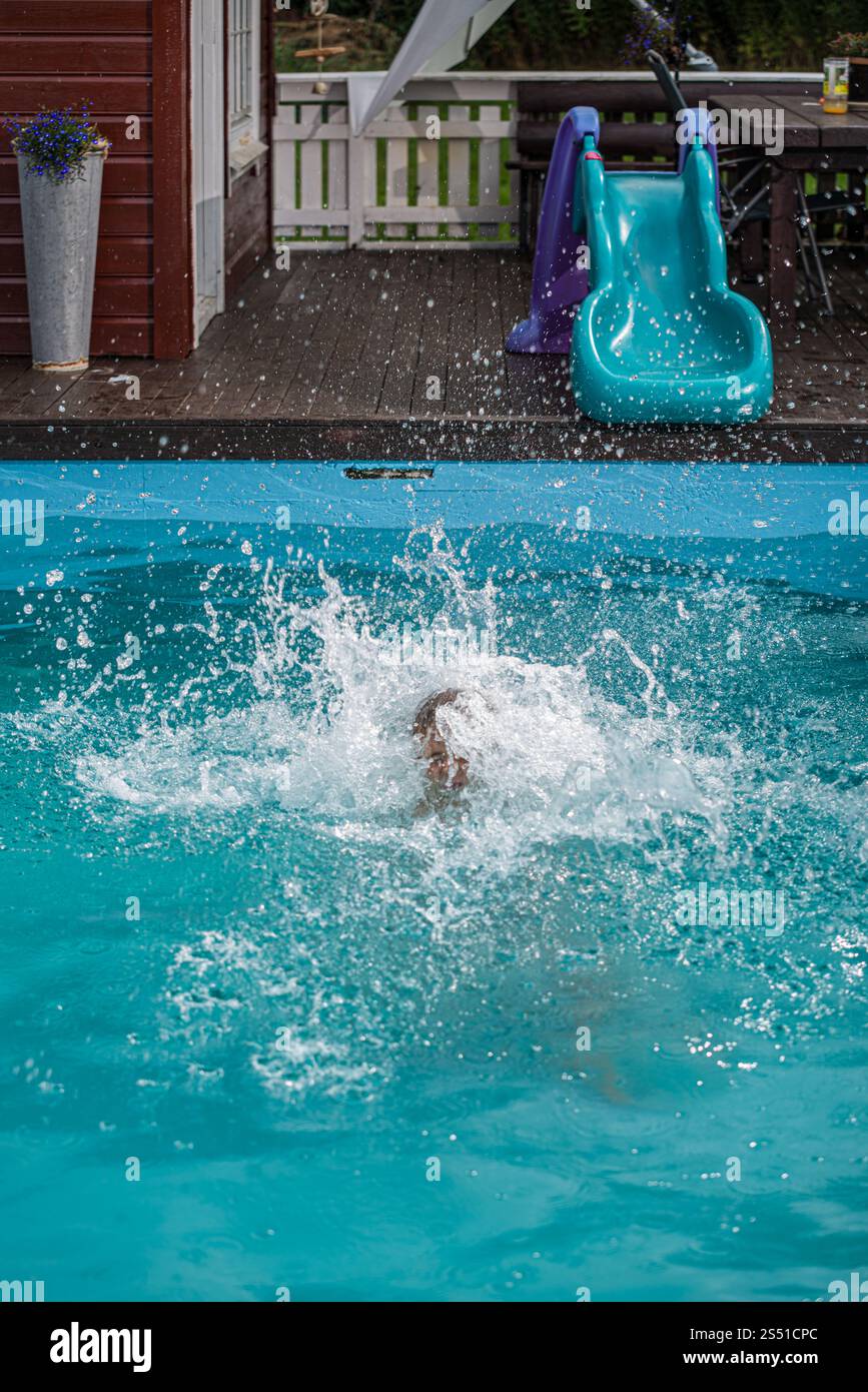 Water splash after a person has jumped in a pool Stock Photo - Alamy