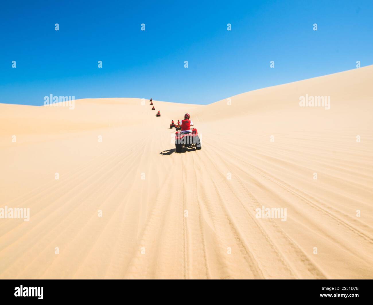 Happy quad bikers driving in sand dunes at Anna bay (Newcastle, NSW ...