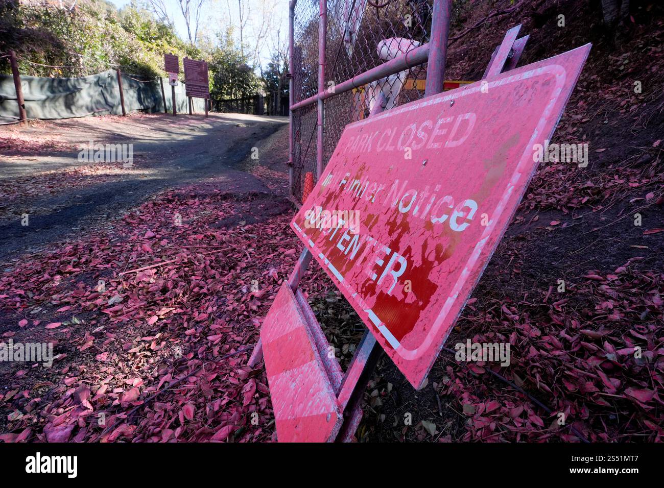 Retardant covers a sign after after crews battled the Palisades Fire in ...