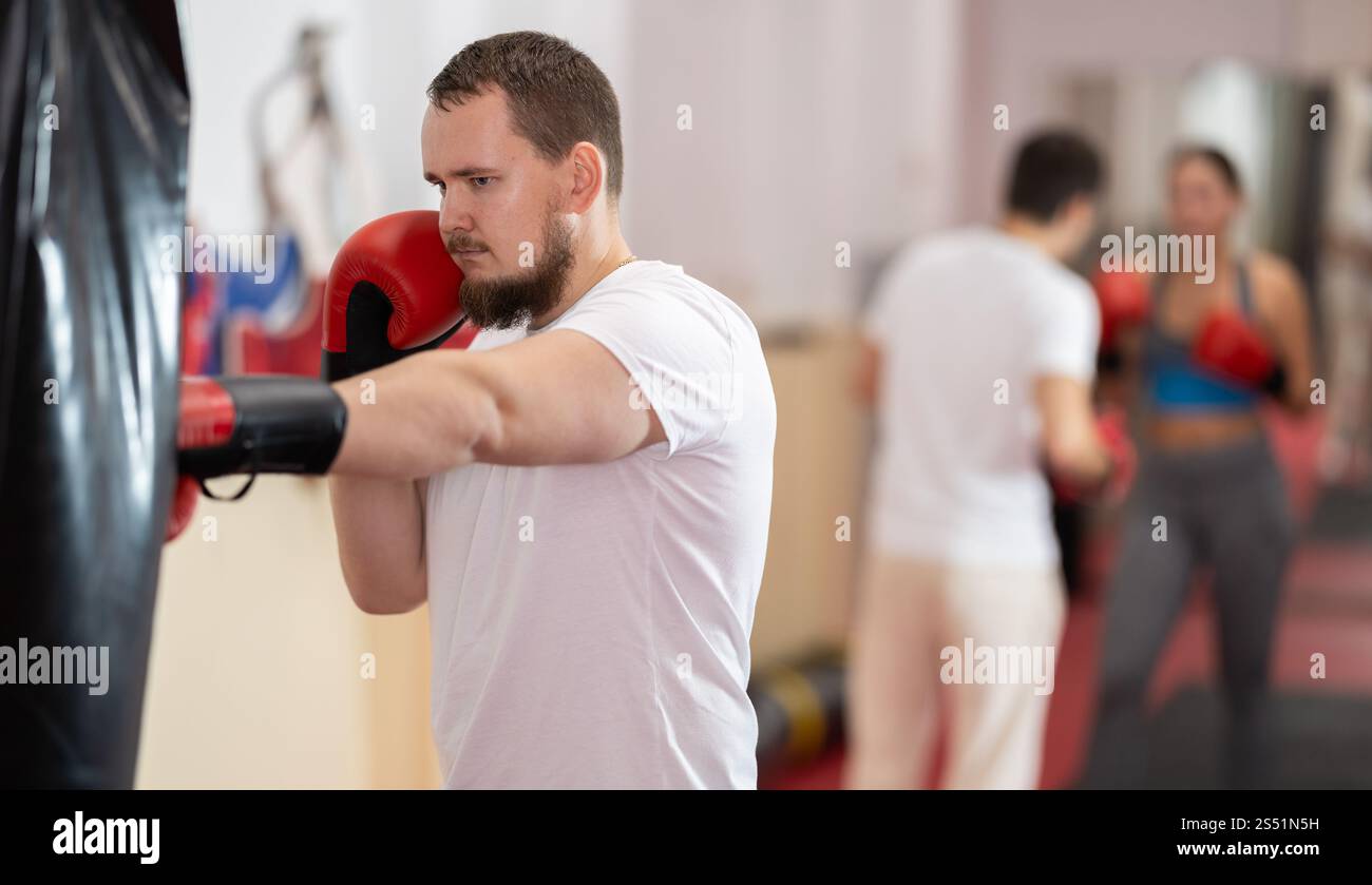 Man boxes a punching bag Stock Photo - Alamy