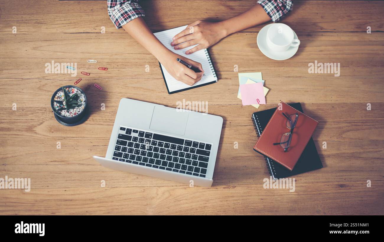 Person writing on notebook coffee hi-res stock photography and images ...