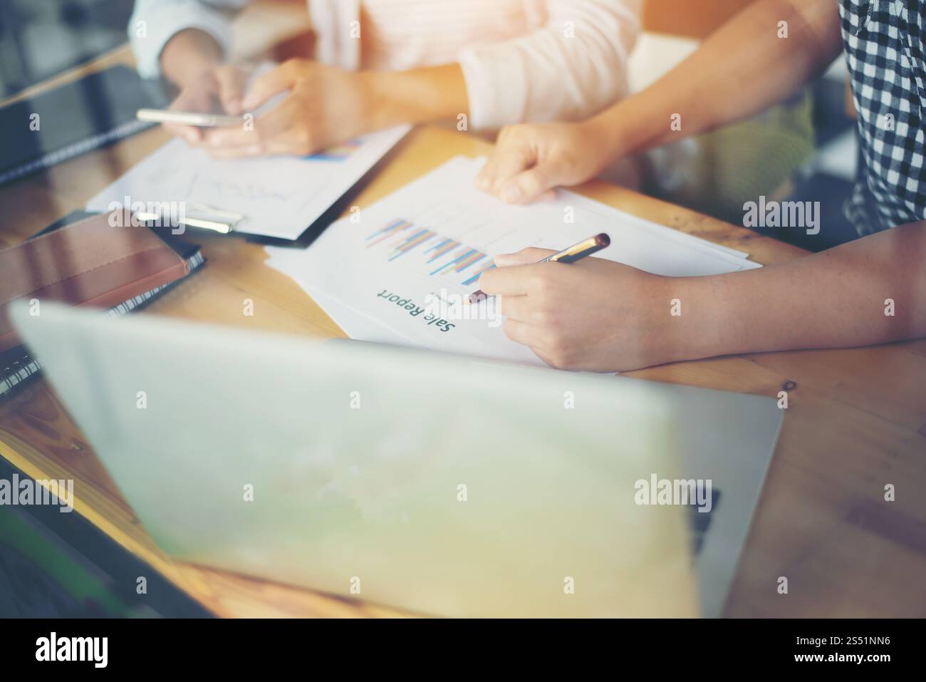 Business team meeting analysis financial chart together at cafe ...