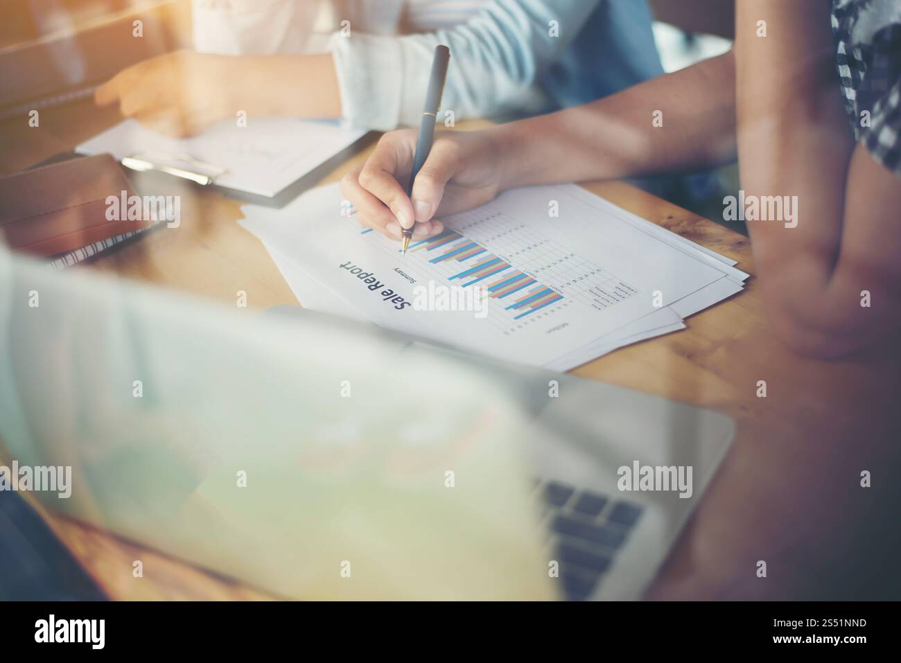 Business team meeting analysis financial chart together at cafe ...