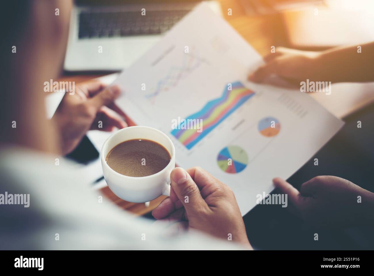 Boss holding a cup of coffee work with secretary about analysis ...