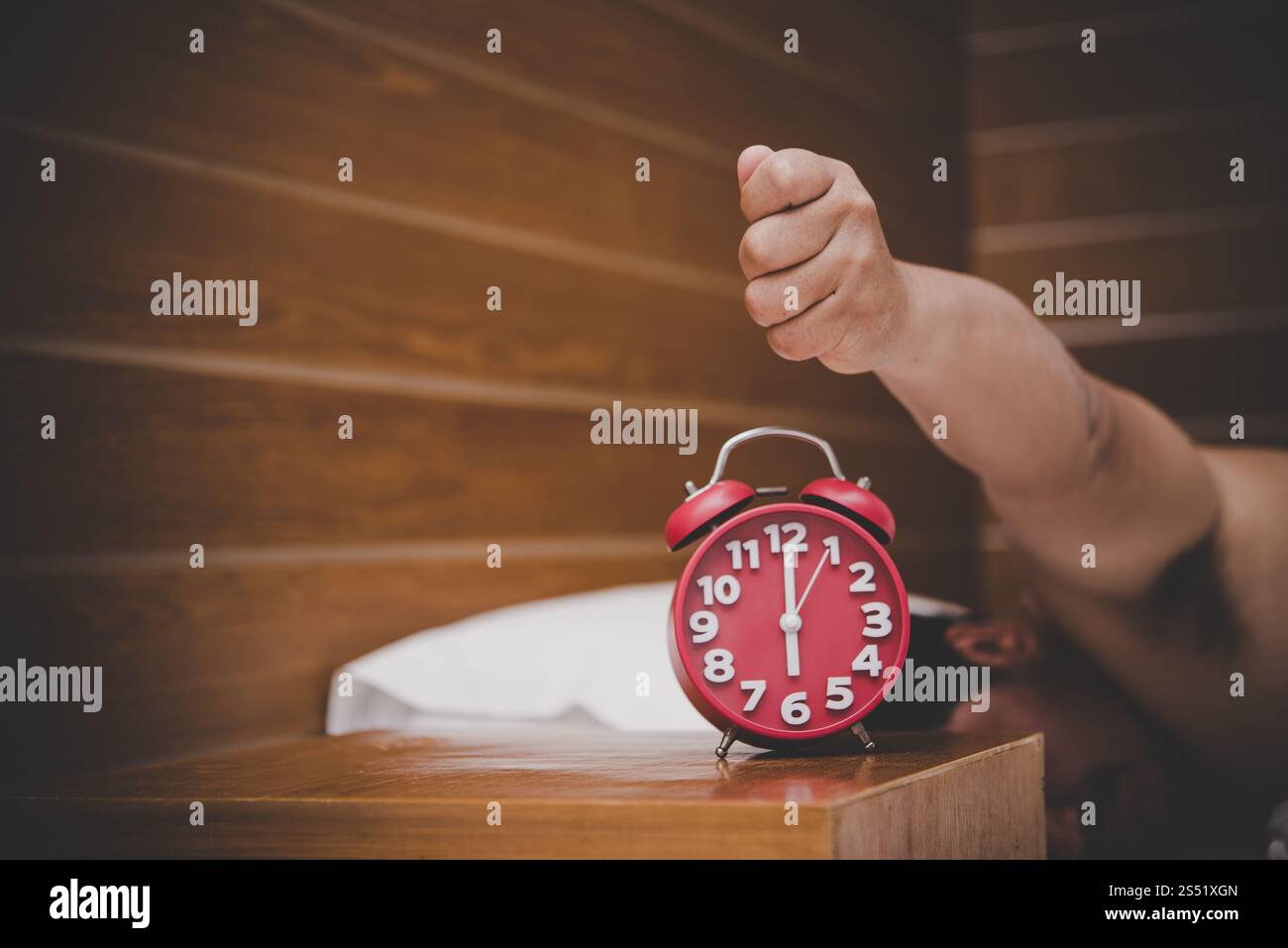 Man being awakened by an alarm clock in his bedroom Stock Photo - Alamy