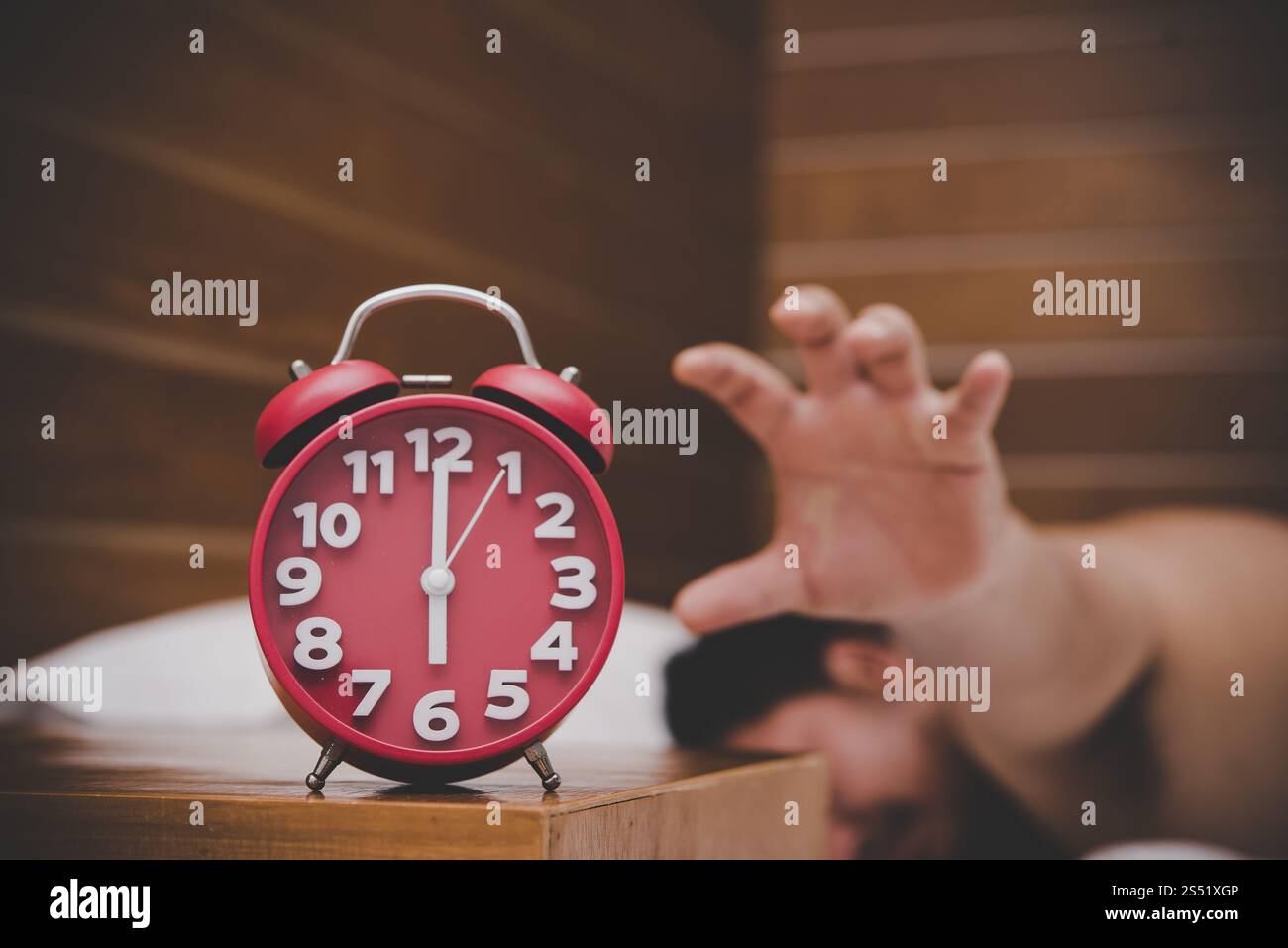 Man being awakened by an alarm clock in his bedroom Stock Photo - Alamy