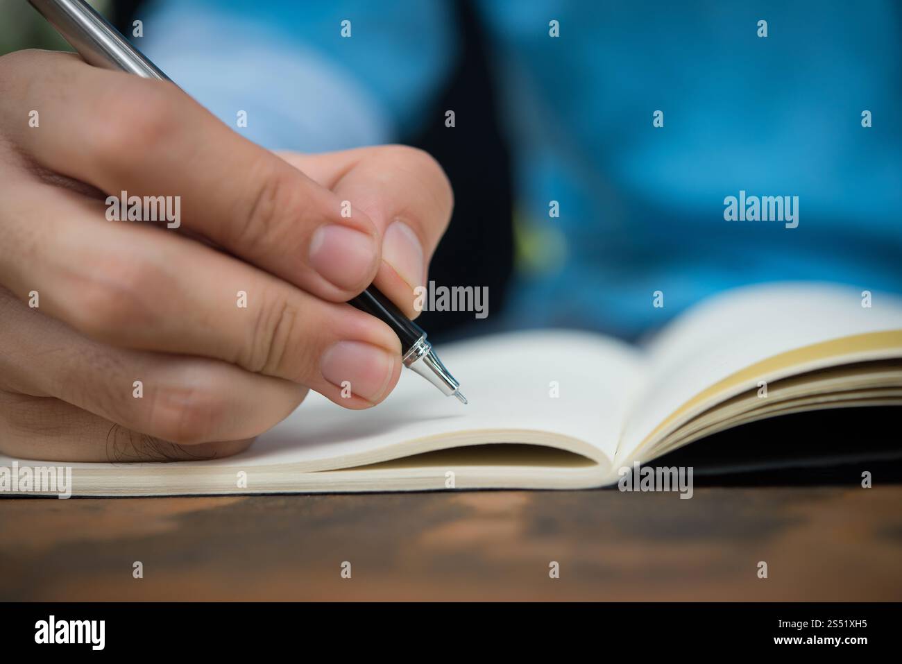 Man Hand write on the notebook Stock Photo - Alamy