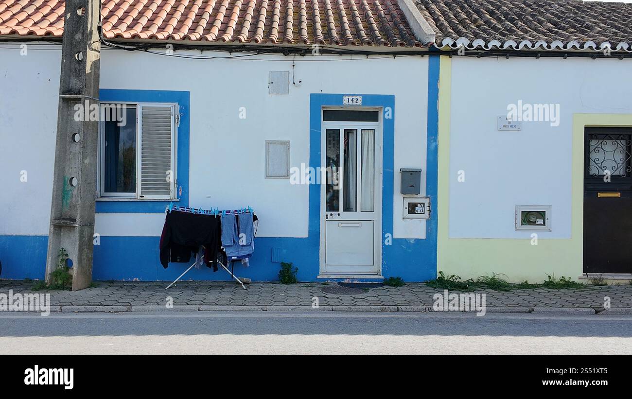 An old house in Portimão, Portugal, with people drying their clothes by ...