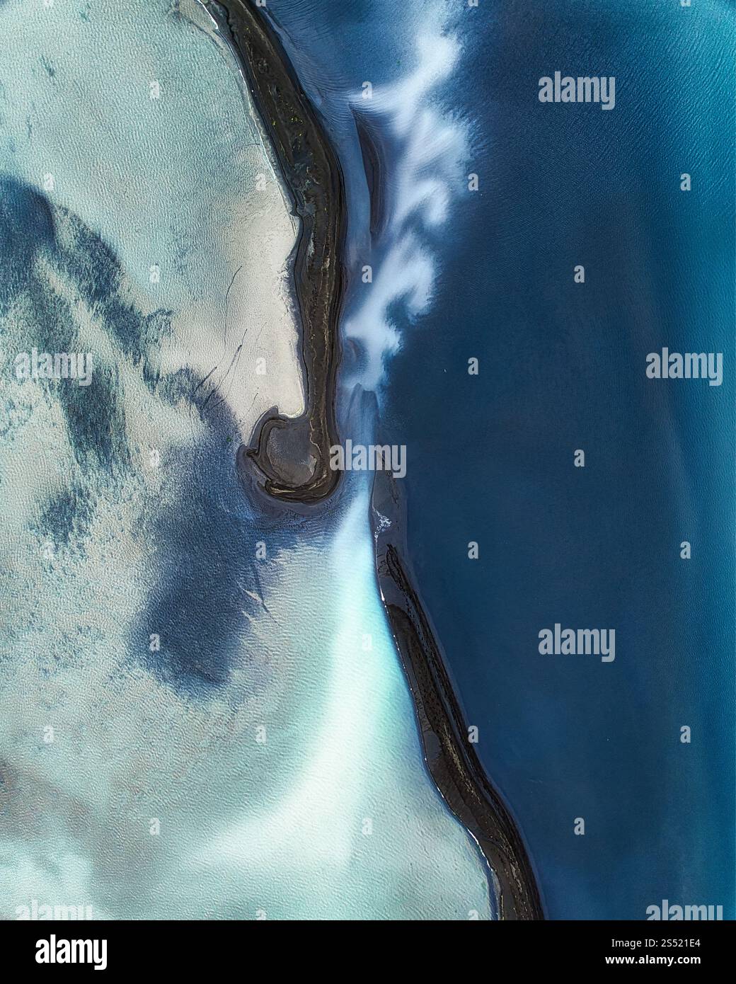 Aerial view of Iceland’s glacial rivers meeting black sands, a stunning ...