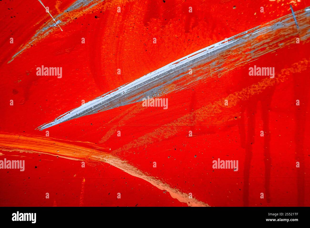 Messy paint strokes and smudges on an old red grunge wall background ...